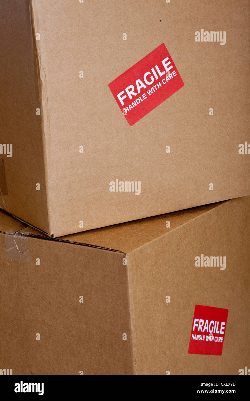 Stack of brown packing boxed with fragile stickers Stock Photo - Alamy