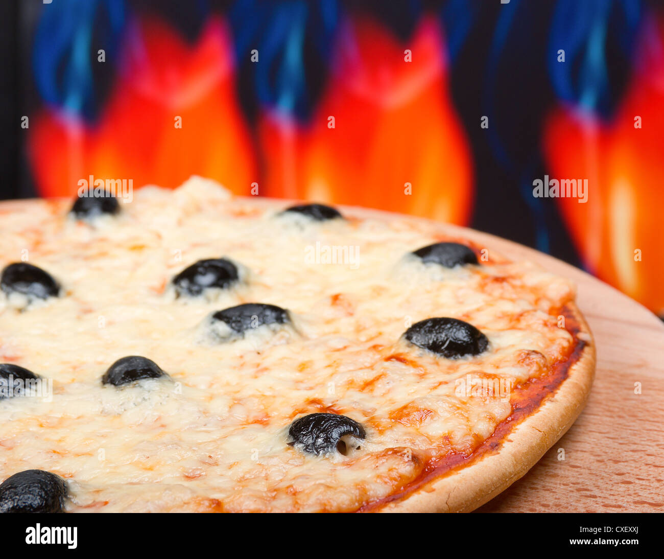 Pizza with fire on background Stock Photo - Alamy