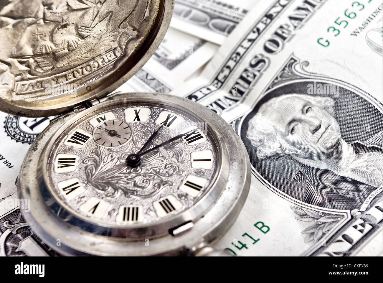 Pocket watch and dollars Stock Photo - Alamy