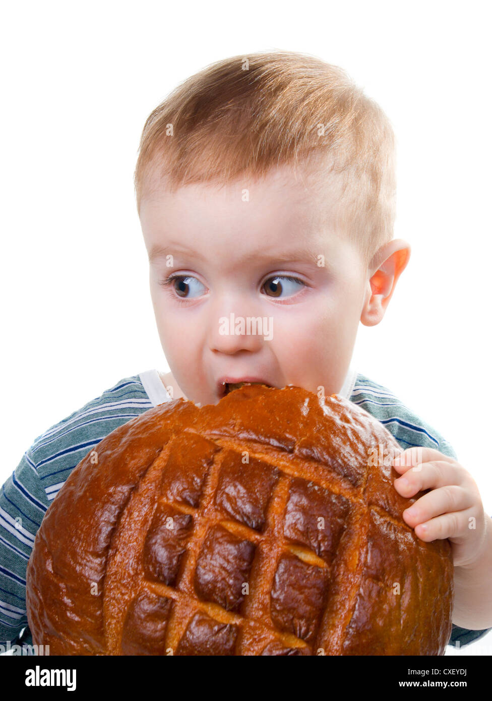A little Caucasian boy eating a bread Stock Photo - Alamy