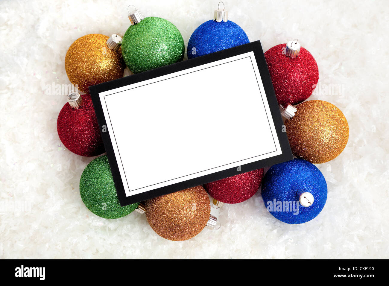 A Christmas themed note-card or message surrounded by baubles and ...