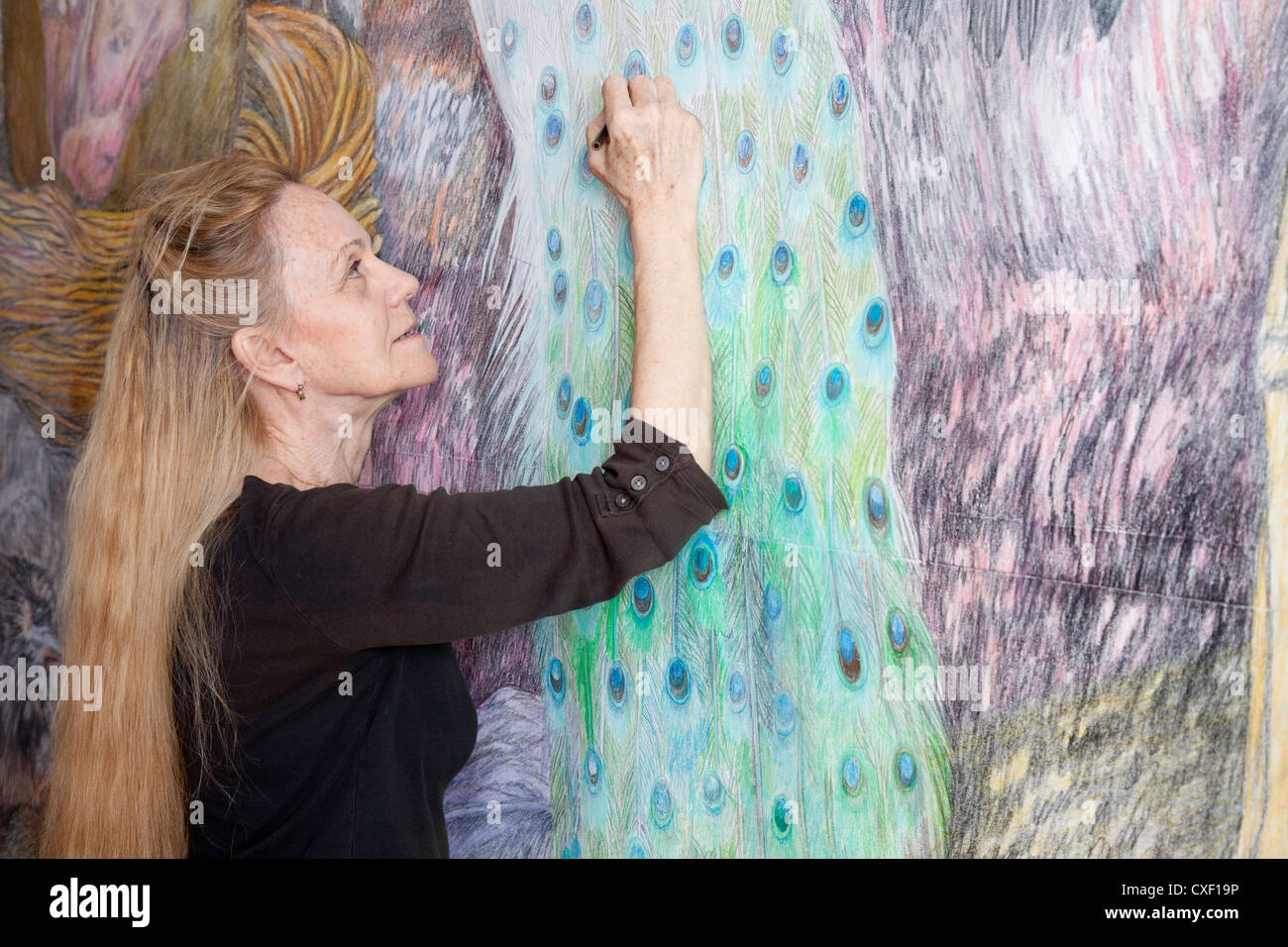 Caucasian woman drawing mural on wall Stock Photo - Alamy