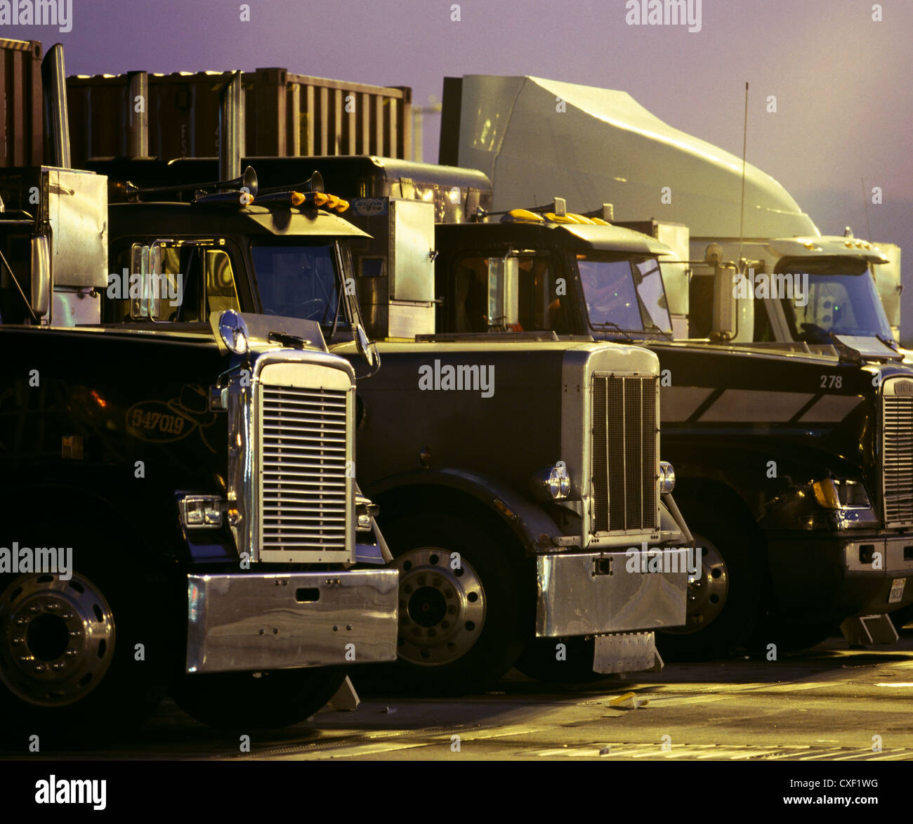 Semi-trucks in a row Stock Photo - Alamy