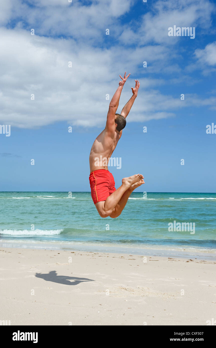 man jumping on the beach Stock Photo - Alamy