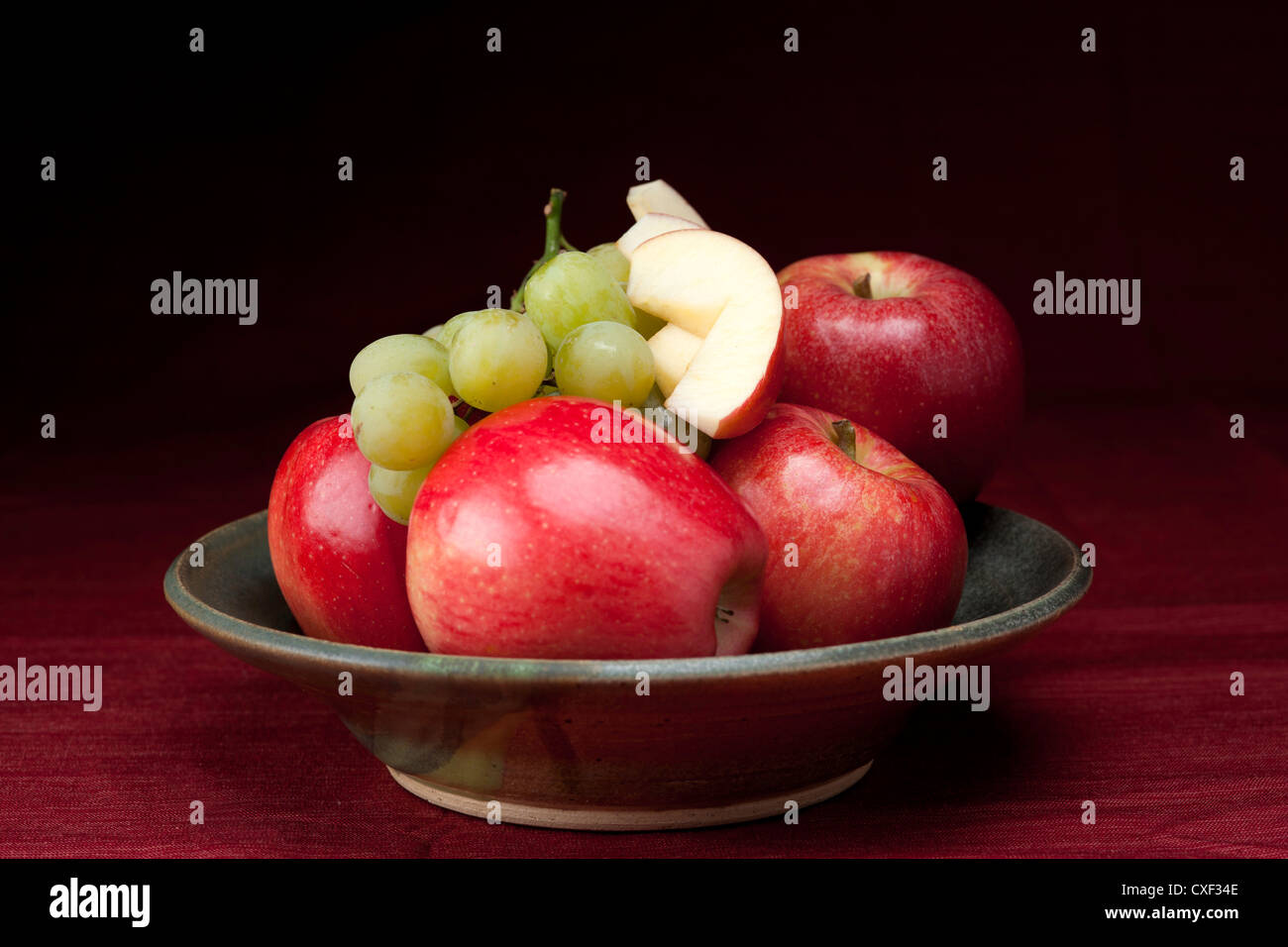 Bowl of whole and sliced fruit Stock Photo - Alamy