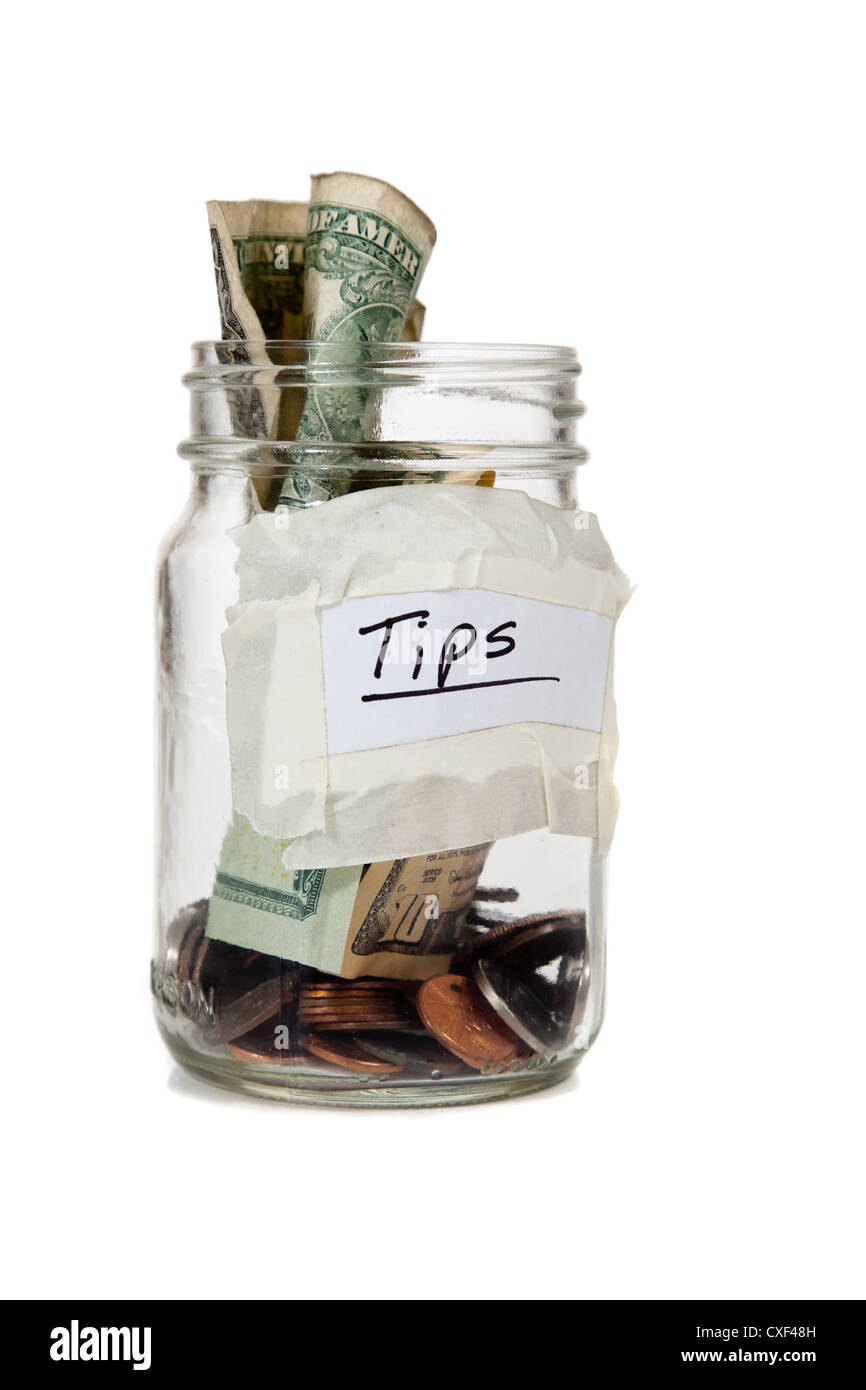 Tip change in a clear jar Stock Photo - Alamy