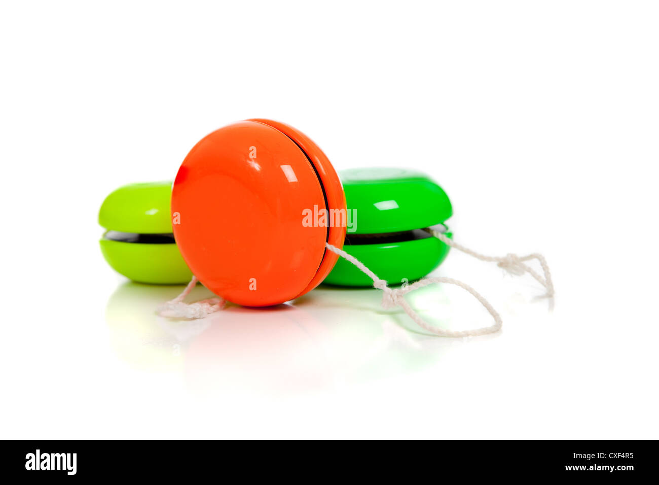 Colorful yo-yos on a white background Stock Photo - Alamy
