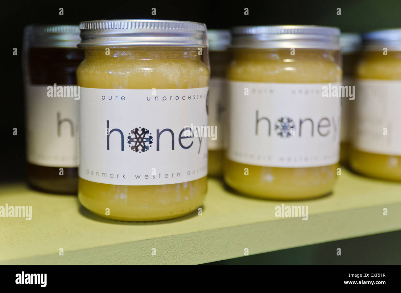 An unprocessed jar of honey on a shelf in a shop, Denmark, Western ...