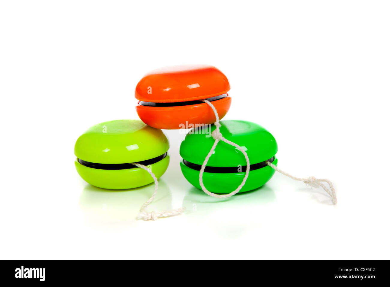 Three yo-yos on a white background Stock Photo - Alamy