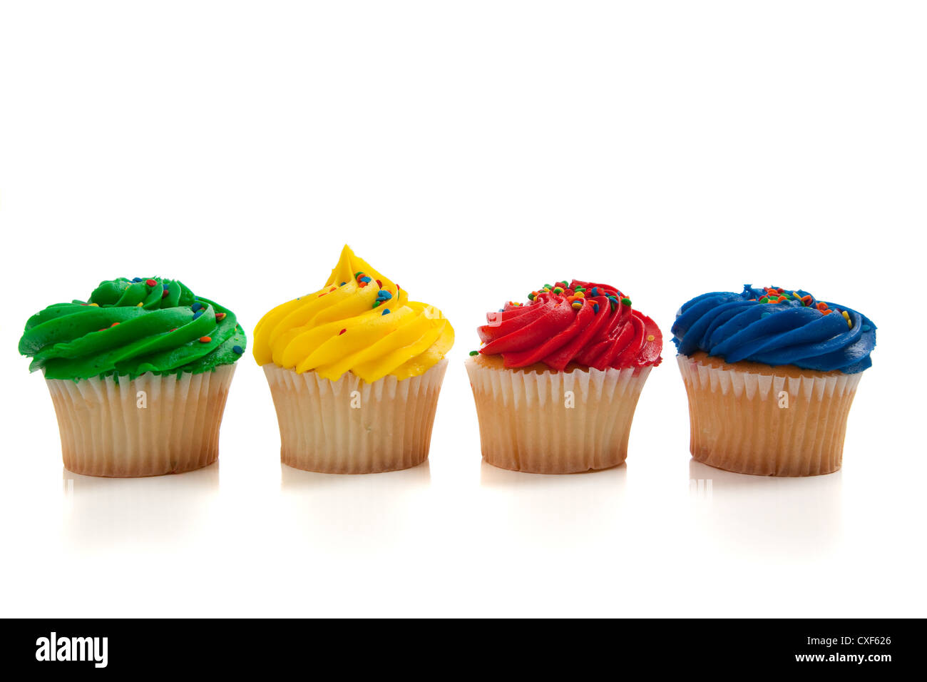 Row of brightly colored cupcakes on a white background Stock Photo - Alamy