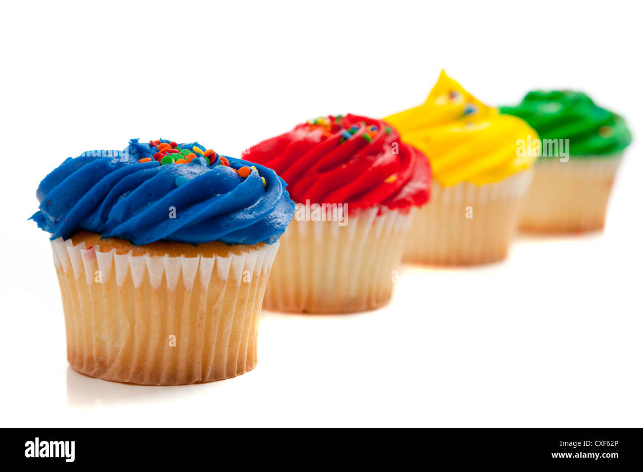 Row of brightly colored cupcakes on a white background Stock Photo - Alamy