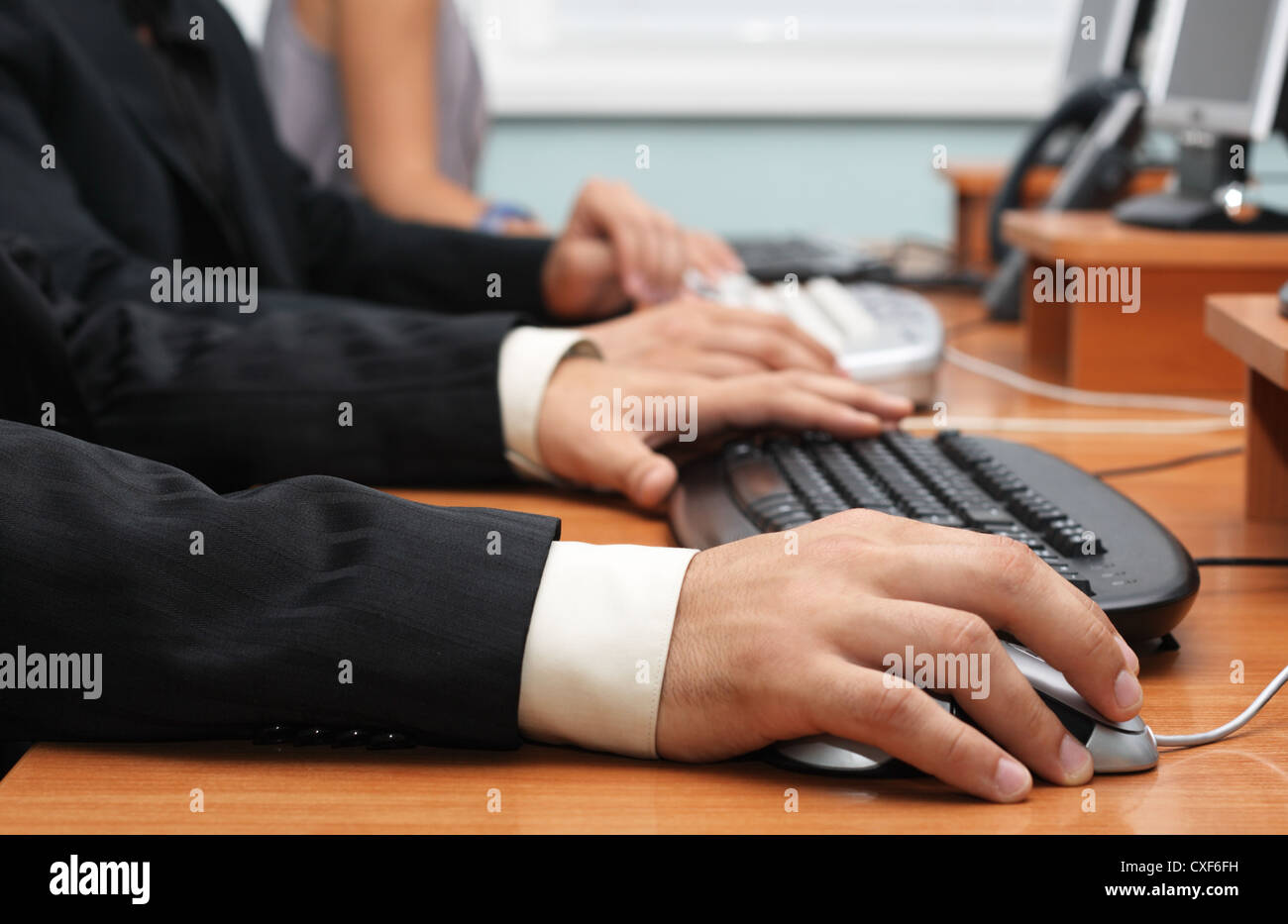 Closeup view of businessman's hands on a mouse and keyboard Stock Photo ...