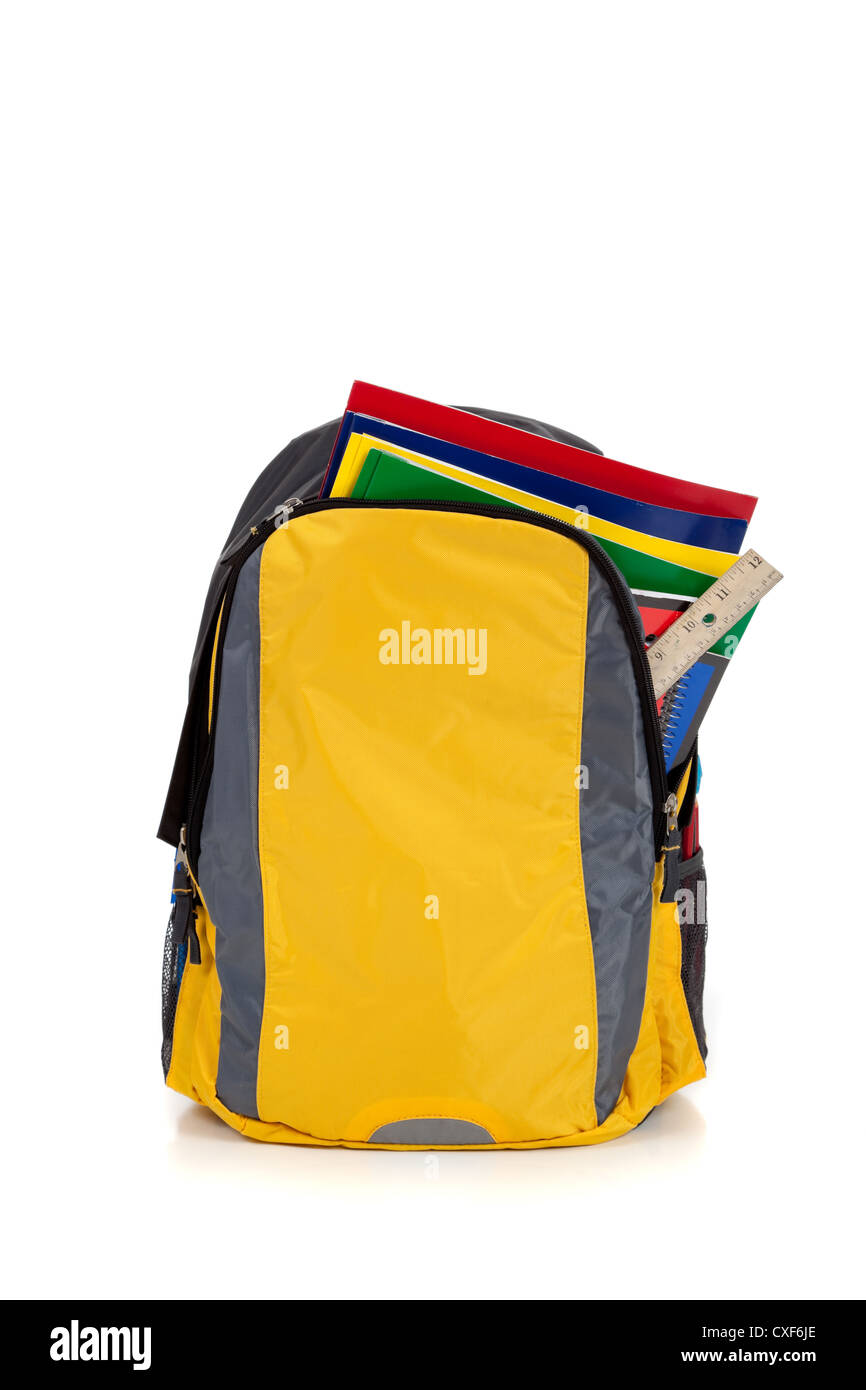 Yellow backpack full of school supplies Stock Photo - Alamy