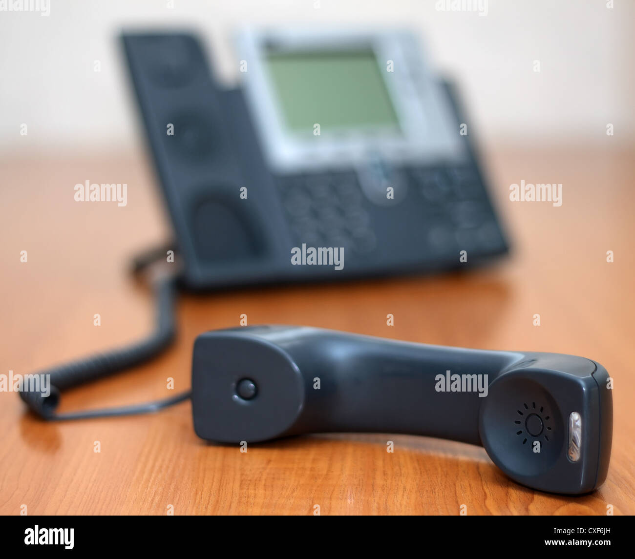 Phone receiver lying on a table Stock Photo - Alamy