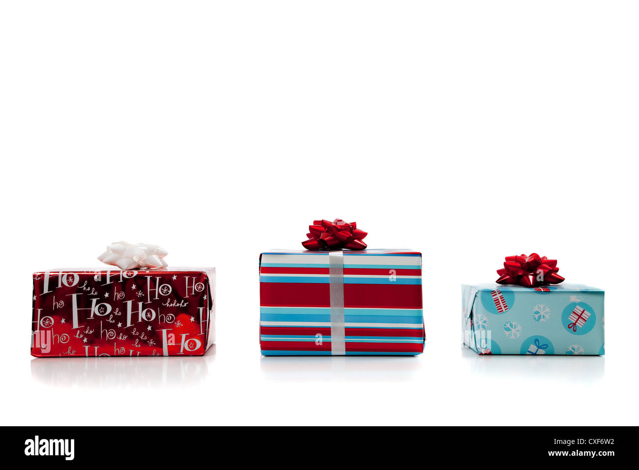 Row of wrapped Christmas presents on a white background Stock Photo - Alamy