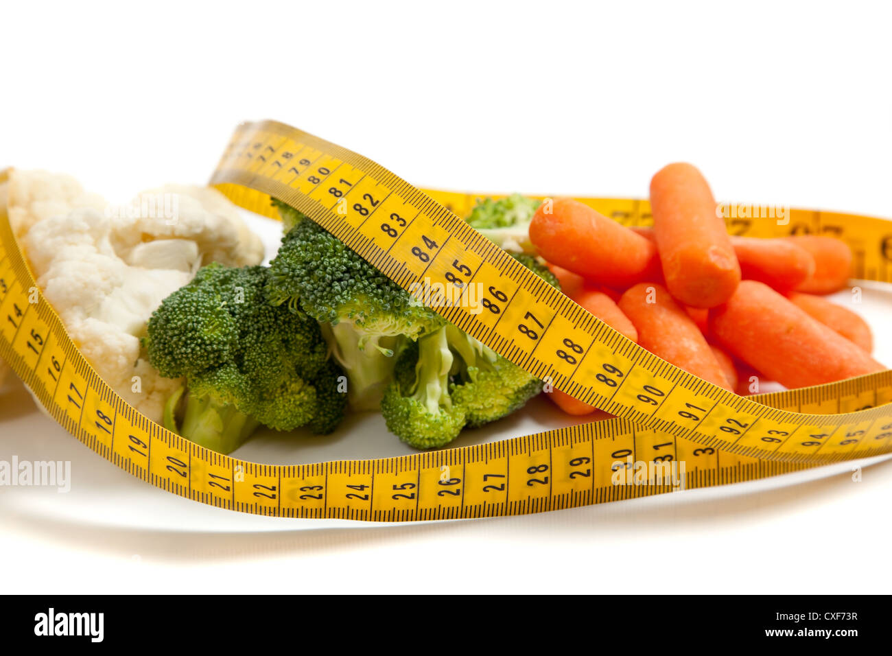 Fresh vegetables with a tape measure Stock Photo - Alamy
