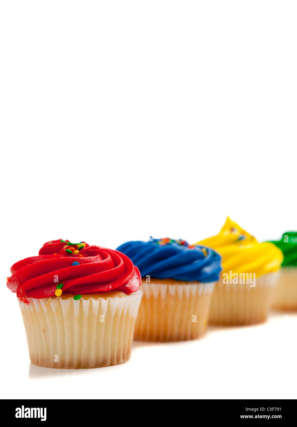 Row of brightly colored cupcakes on a white background Stock Photo - Alamy