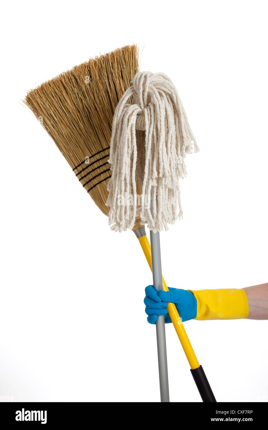 Rubber gloved hand holding a straw broom and a string mop Stock Photo ...
