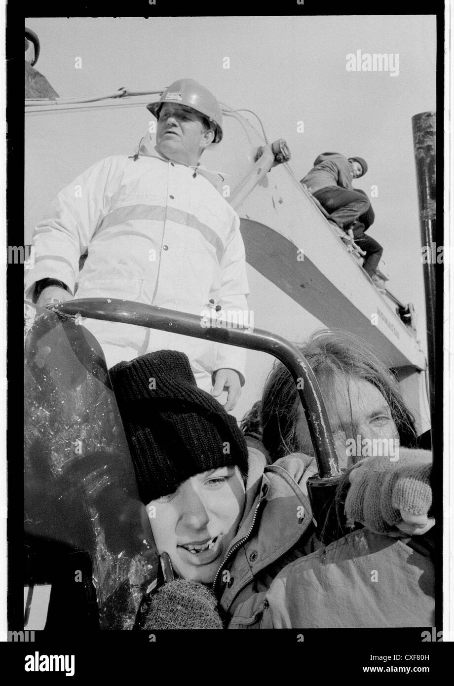 Group 4 security stands above protesters locked on to earth moving ...