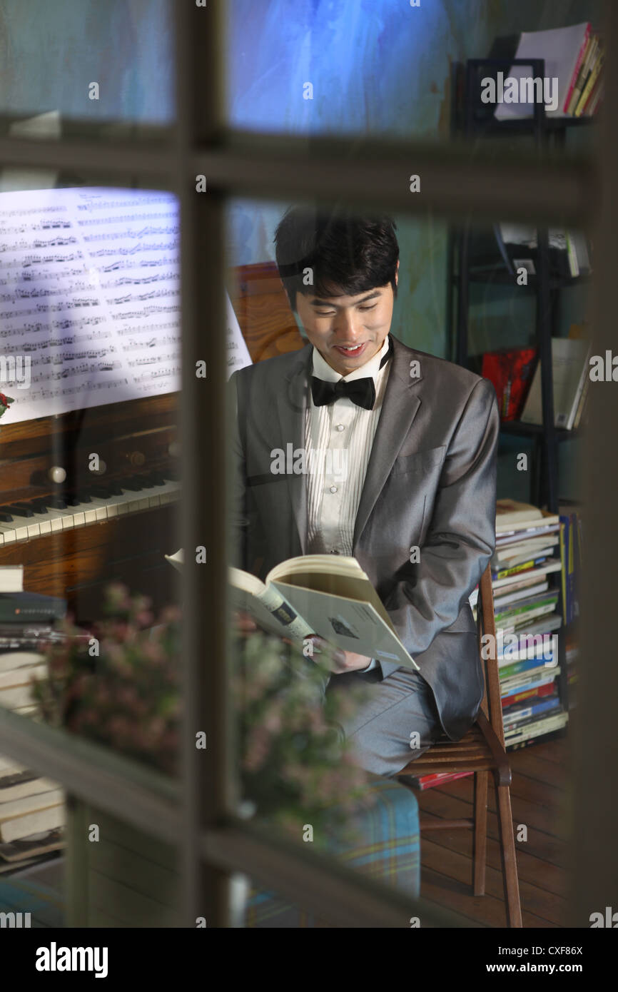asian man is reading book,indoors Stock Photo - Alamy