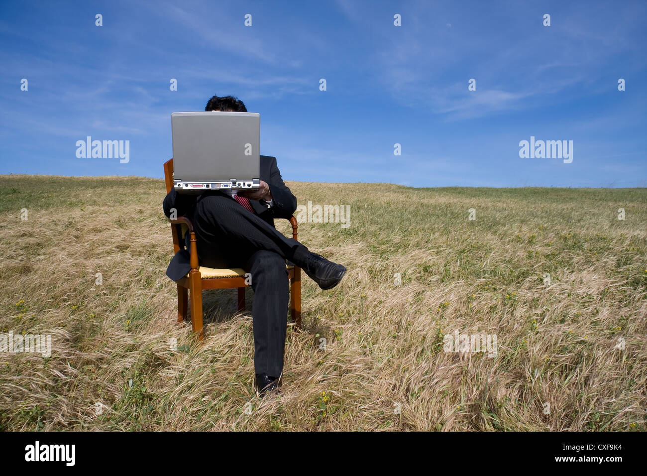 Business man sitting on a chair working out Stock Photo - Alamy