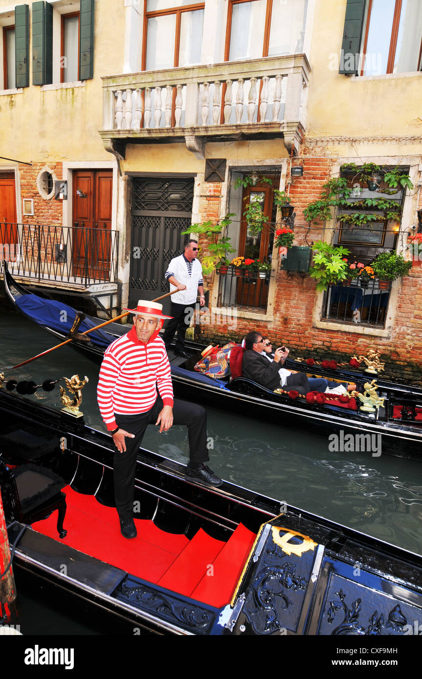 Venice, Italy - 06 May, 2012: Gondolier inviting tourists to ...