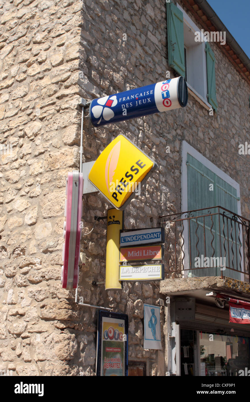 Advertising signs outside a newsagent tobacconist in the village of ...