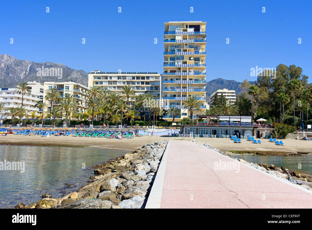 Pier, beach and apartment buildings in resort town of Marbella on Costa ...