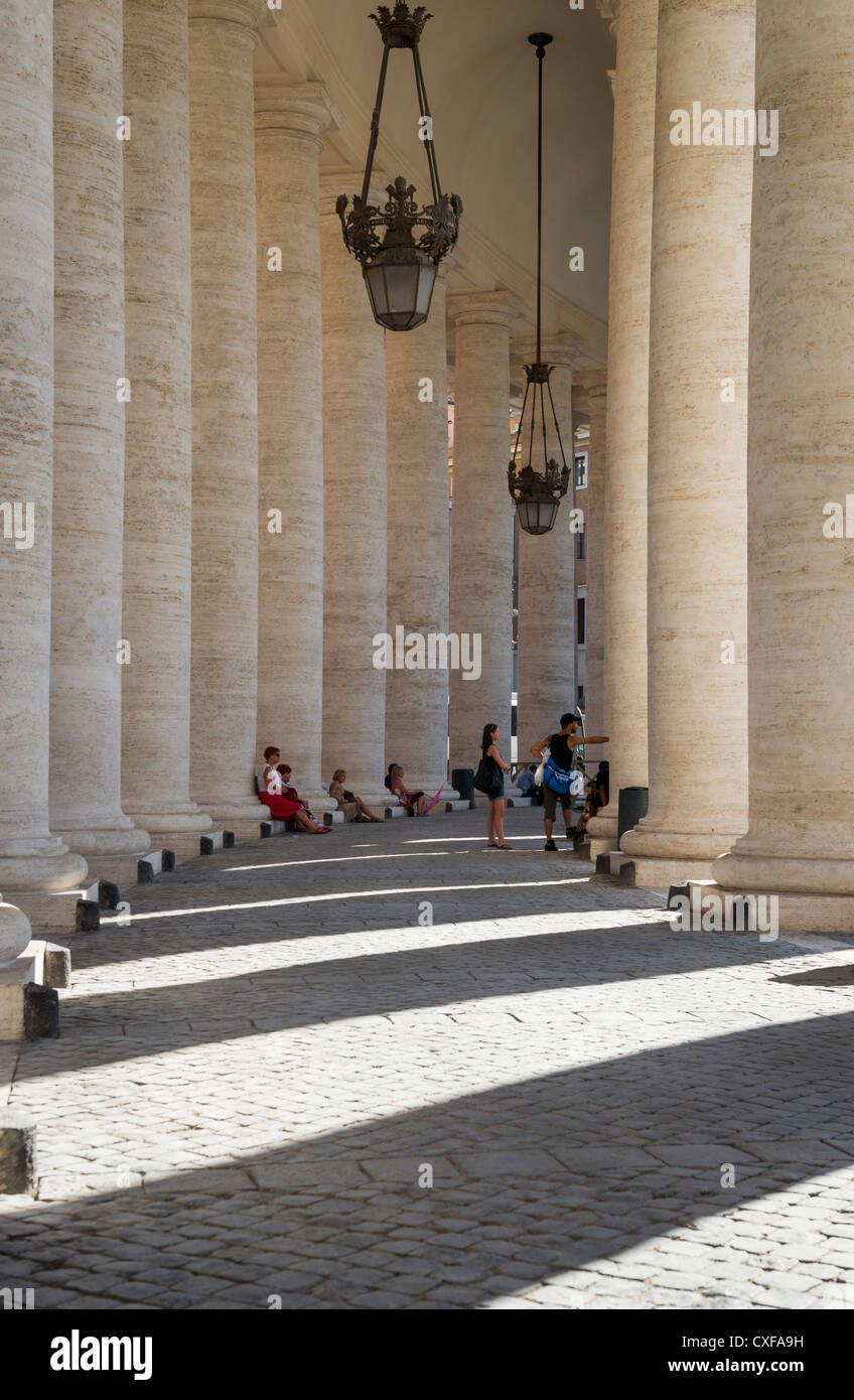 People sitting between the facade of basilica of saint Peter, Vatican ...