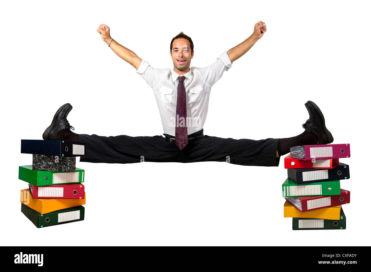 Businessman doing splits over stack of files Stock Photo - Alamy