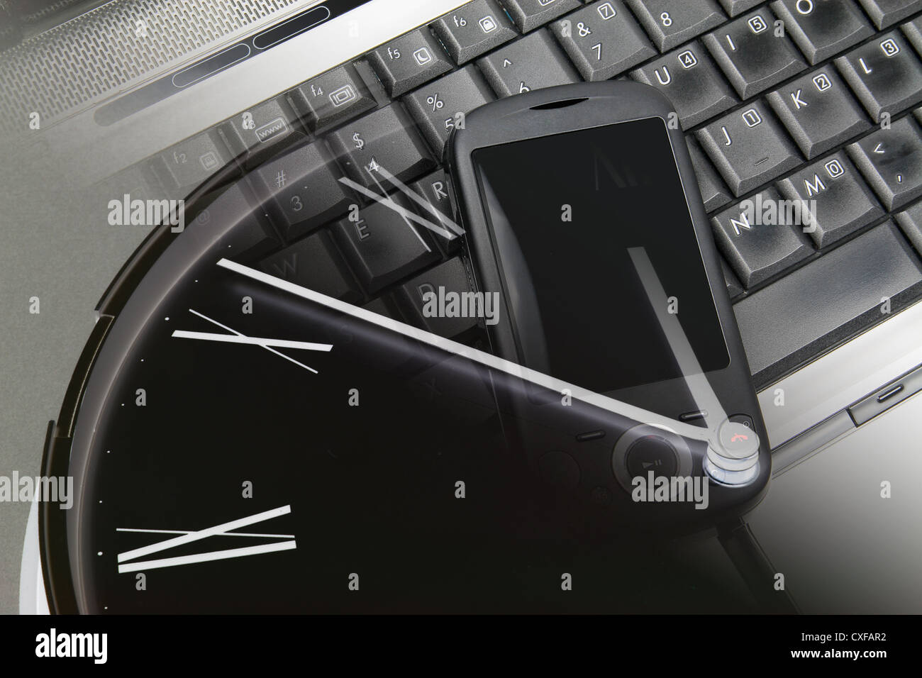 Clock with Laptop and Smart Phone Stock Photo - Alamy