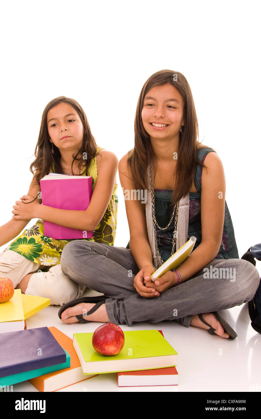 Two sisters doing shool homework isolated in white Stock Photo - Alamy