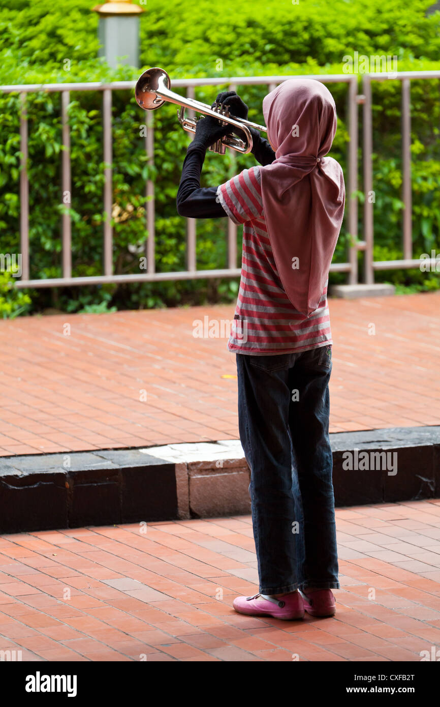 Student playing a Trumpet on the Ground of the Istqlal Mosque in ...