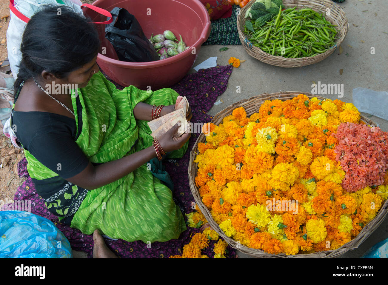 Indian woman selling Marigold flowers for making garlands on an Indian ...
