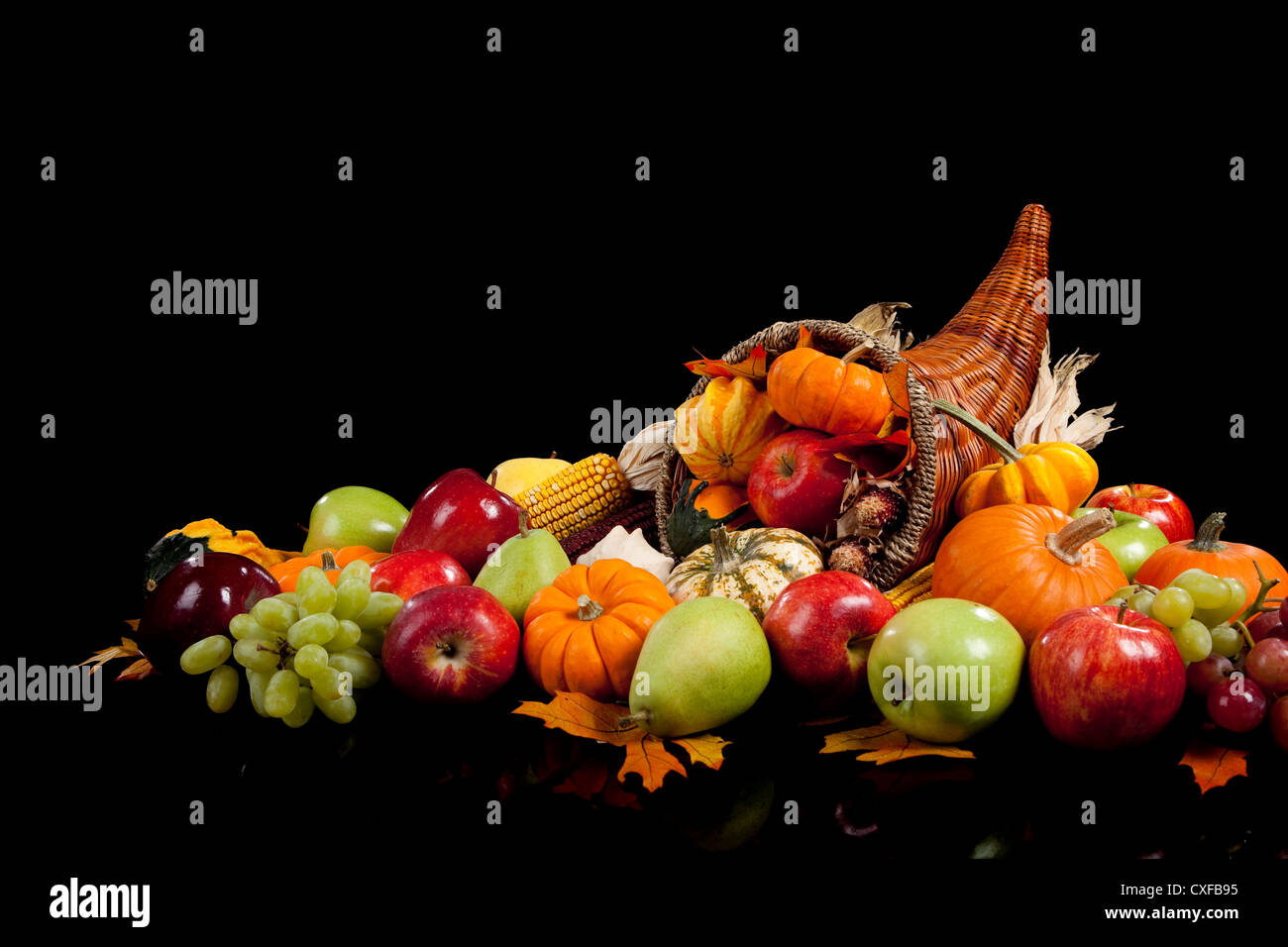 Full cornucopia on a black background Stock Photo - Alamy