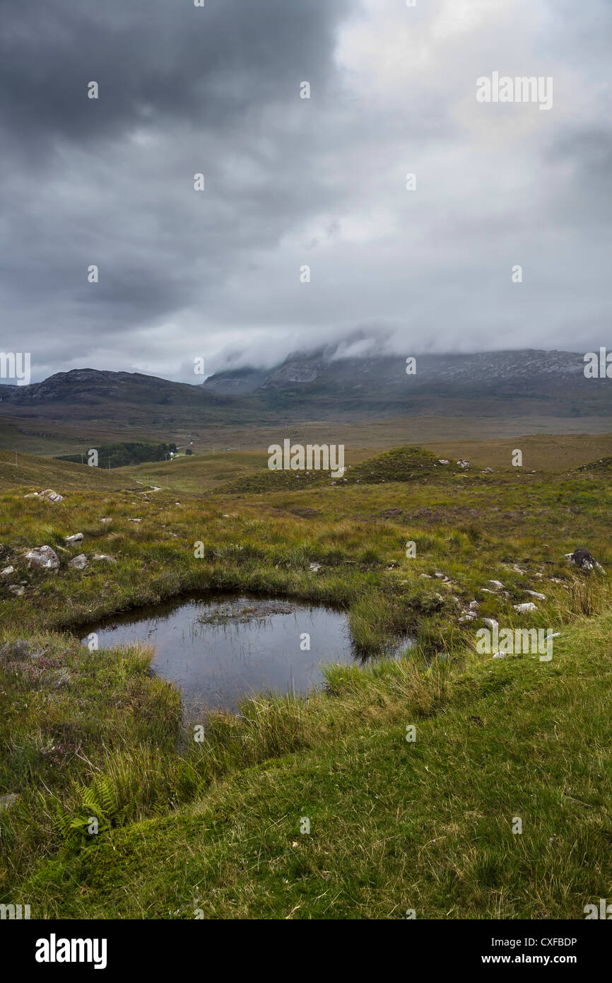 Highland pool under low cloud covering mountain range, Glenshieldaig ...