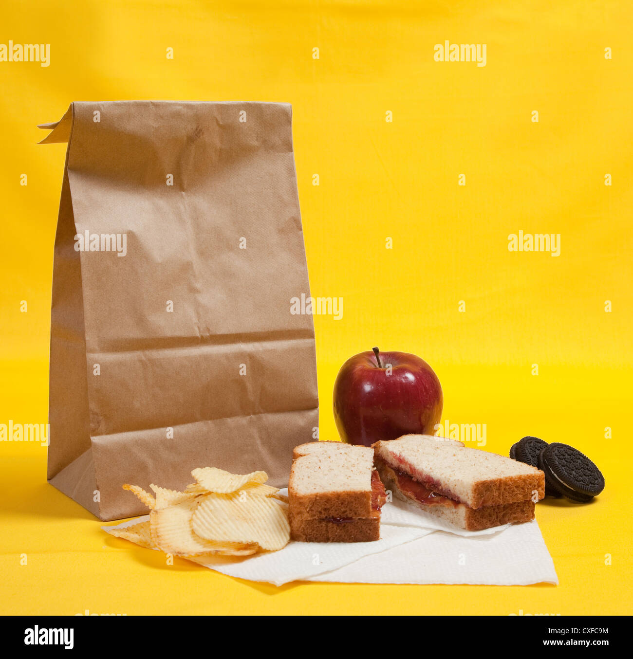 Sack lunch on a yellow background Stock Photo - Alamy