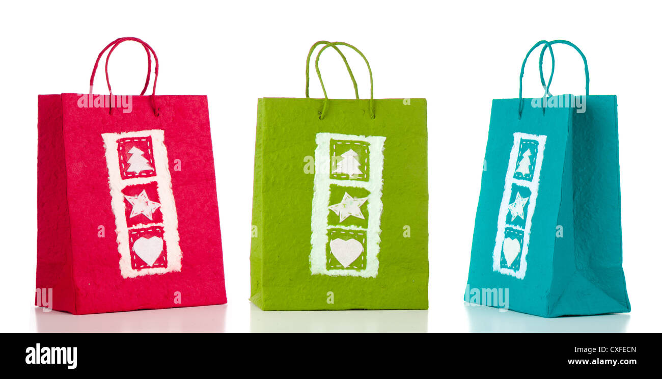 Three paper bags on white reflective background Stock Photo - Alamy