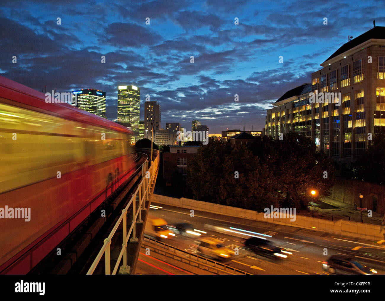 Night view of DLR train at East India DLR station showing Canary Wharf ...