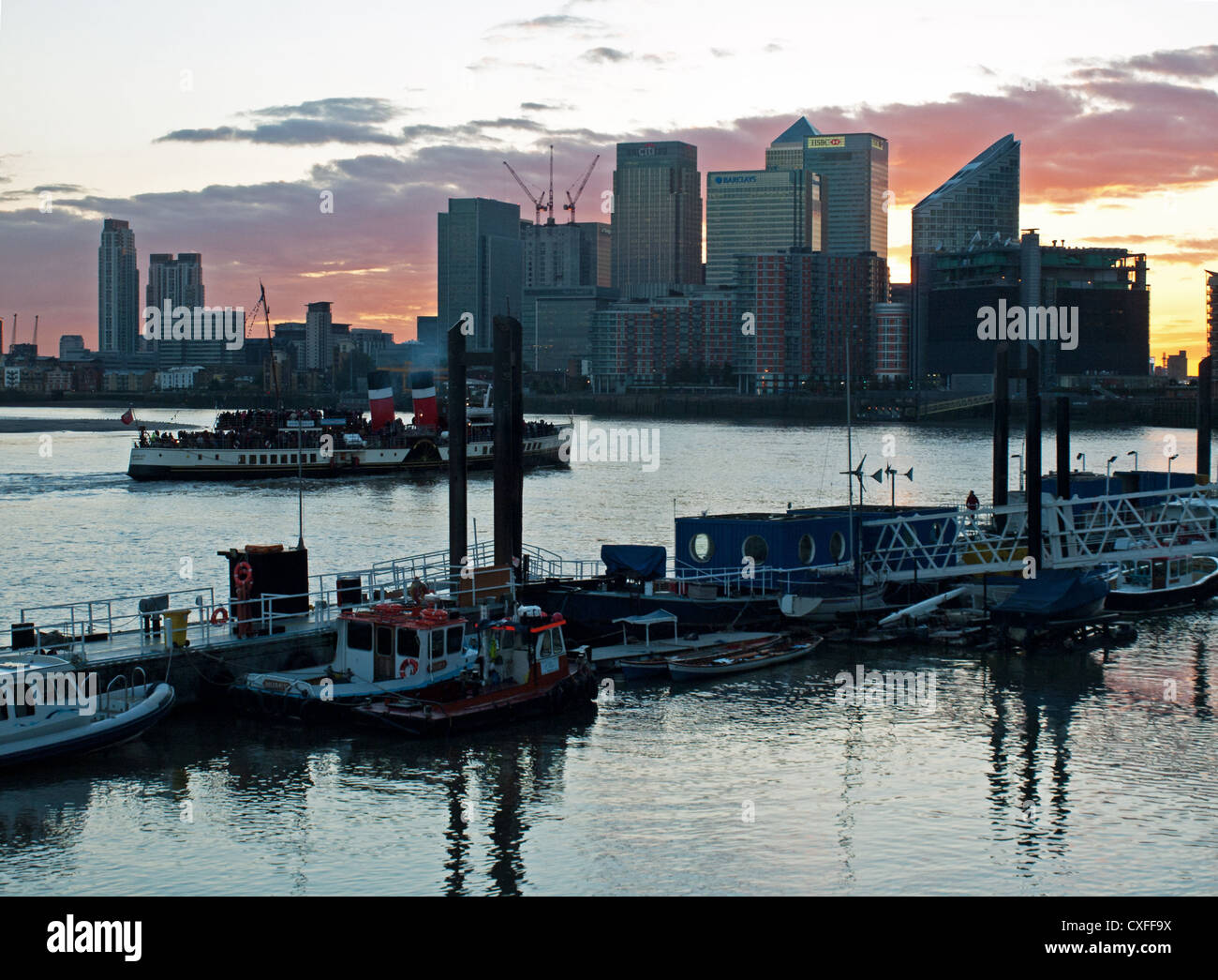 Sunset view of Canary Wharf showing River Thames and Thames Clippers ...