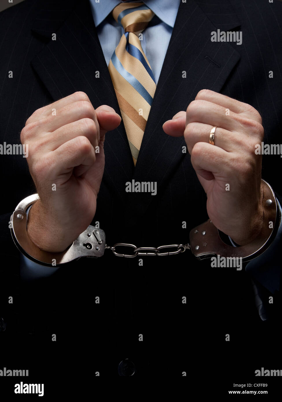 man in a business suit in handcuffs Stock Photo - Alamy