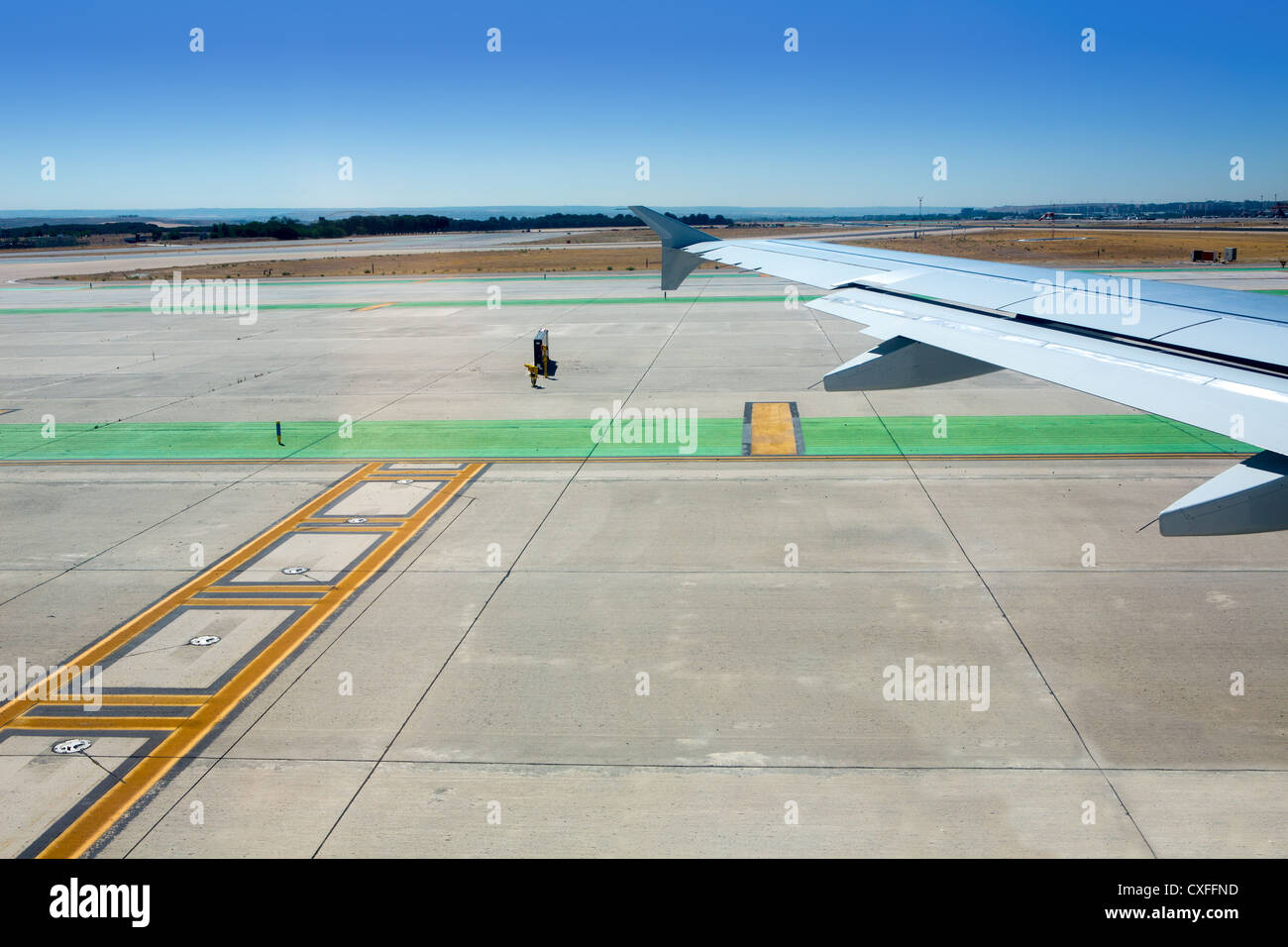 Airplane wing leaving the airport with airstrip road signs Stock Photo ...