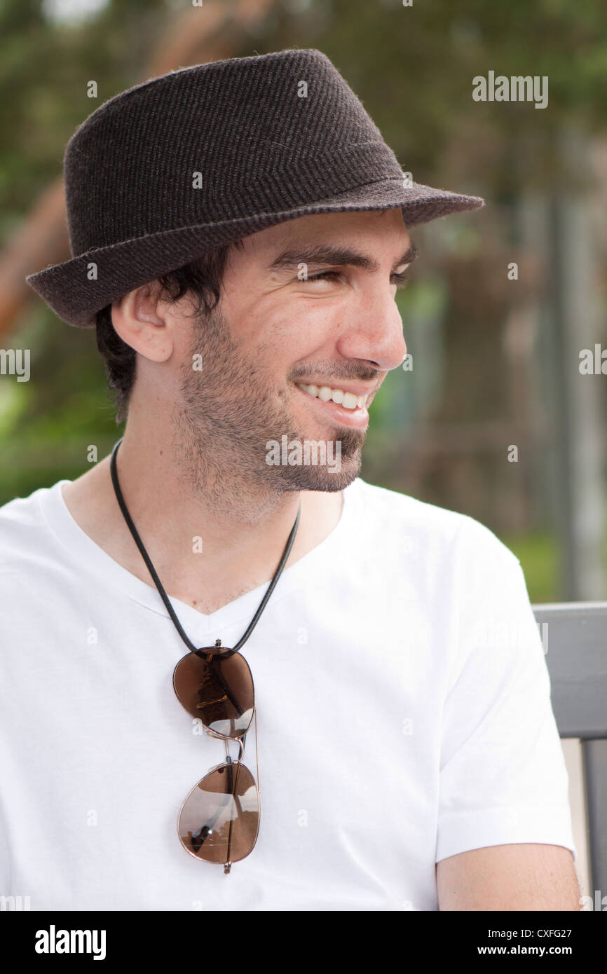 Man with a hat and white T-shirt Stock Photo - Alamy