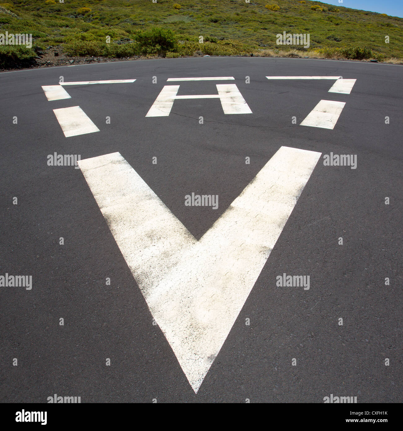 heliport triangle white soil painted sign in pavement Stock Photo - Alamy