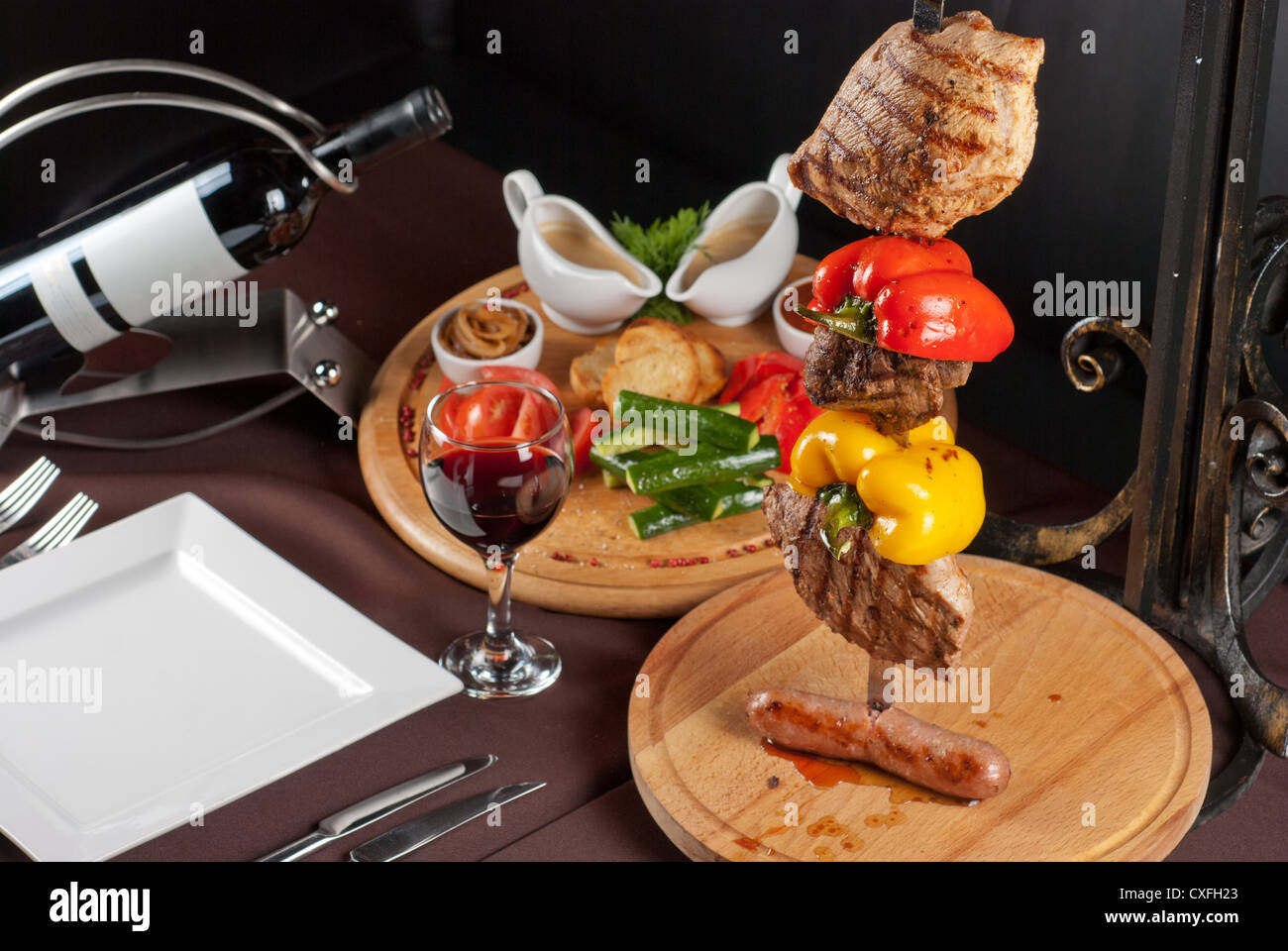 Big tasty roasted meat cuts at skewer on a decorated table Stock Photo ...