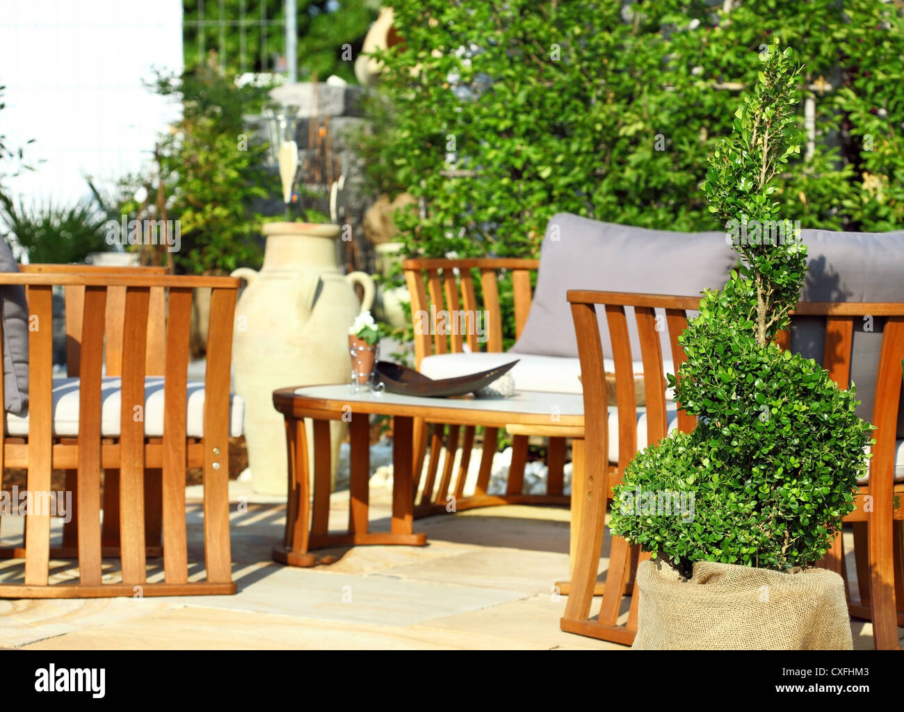 Garden terrace with wooden furniture and plants Stock Photo - Alamy