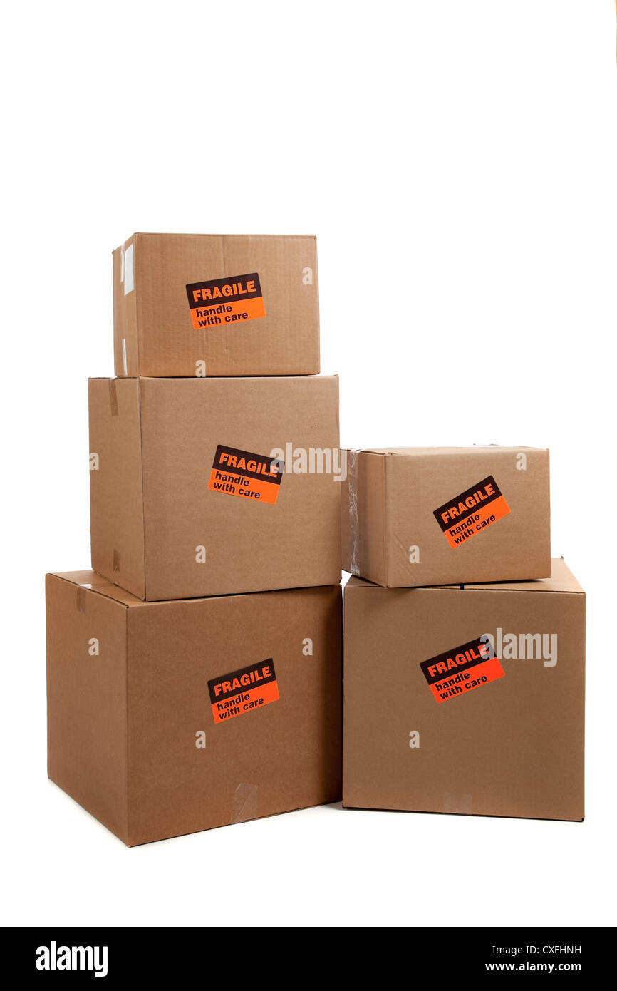 Stacks of brown packing boxes with orange Fragile stickers on a white ...