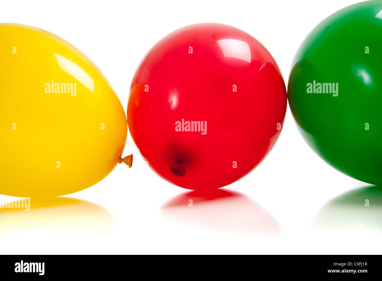 a row of primary colored balloons on a white background Stock Photo - Alamy