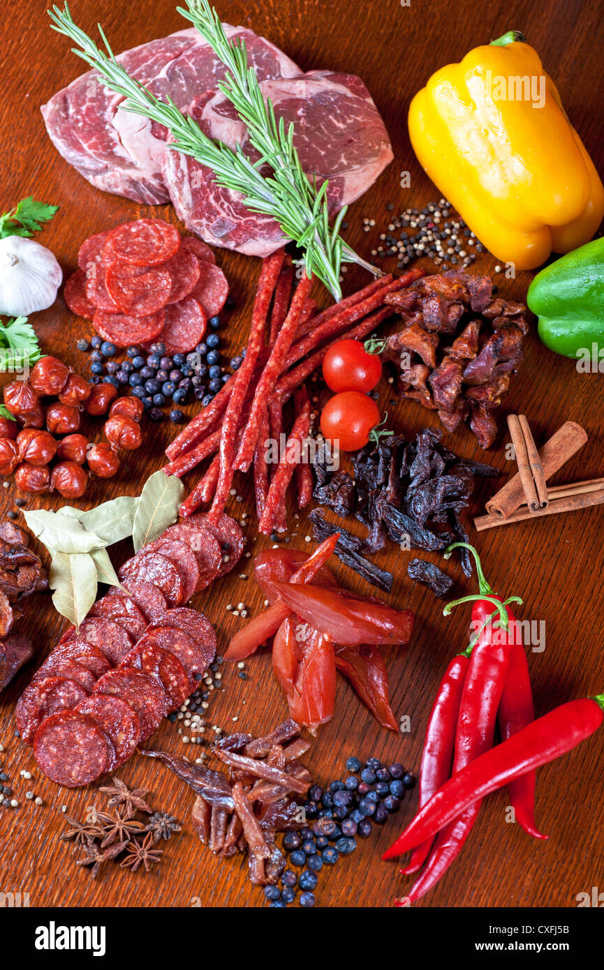 different sausage and meat on a celebratory table with spices and ...