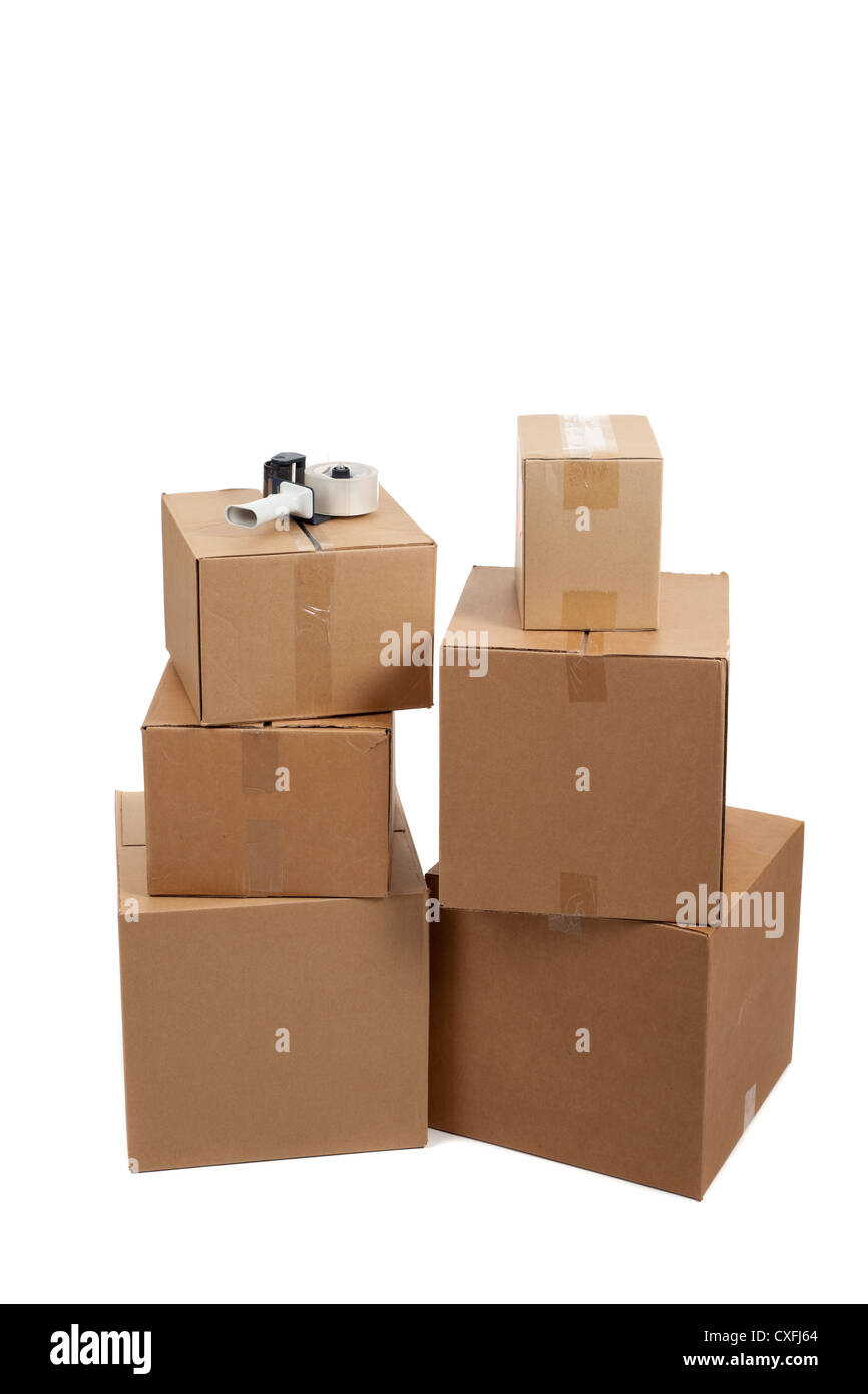 Stacks of brown packing boxes with a tape gun on a white background ...
